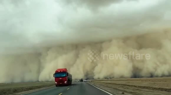 Cars drive through huge sandstorm across desert road in China - Buy ...
