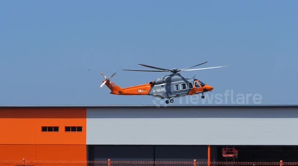Drone filmed flying over helicopter whilst taking off from its base at ...